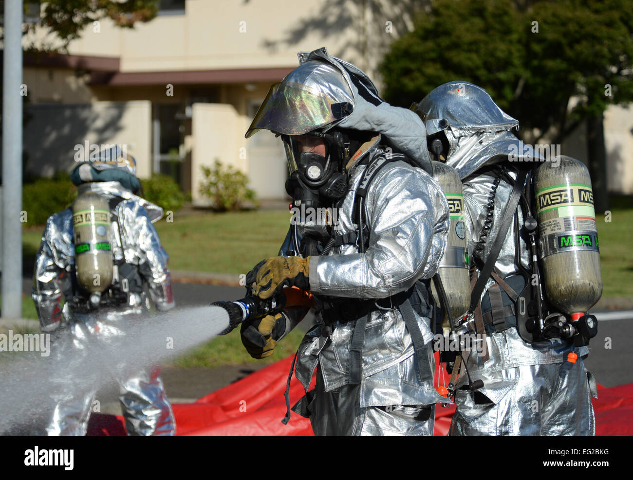 A 374th Civil Engineer Squadron fire fighter checks the pressure of the ...