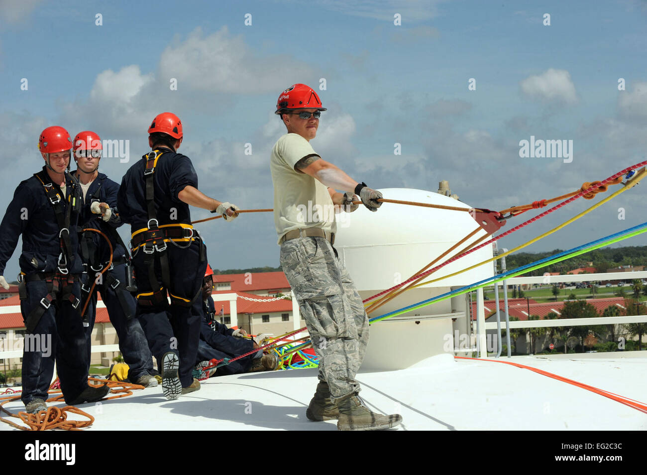 Airmen prepare the lines used to rappel in between two fuel tanks at ...