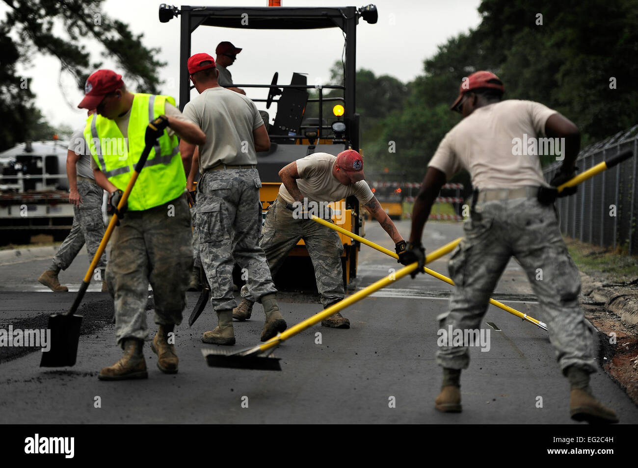 Airmen assigned to the 823rd RED HORSE Squadron, sweep, shovel and rake ...