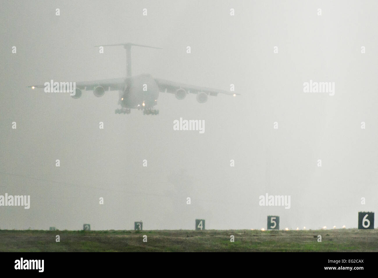 A C-5M Super Galaxy lands on a foggy runway Dec. 10, 2014, at Travis ...