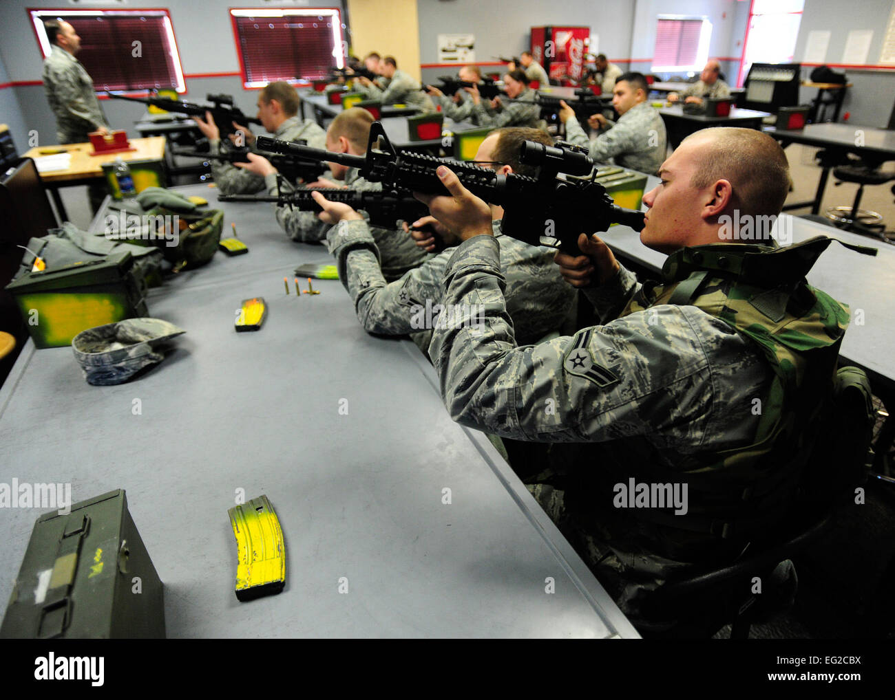 Airman 1st Class Dylan Stefani, front, looks through the sights of his ...