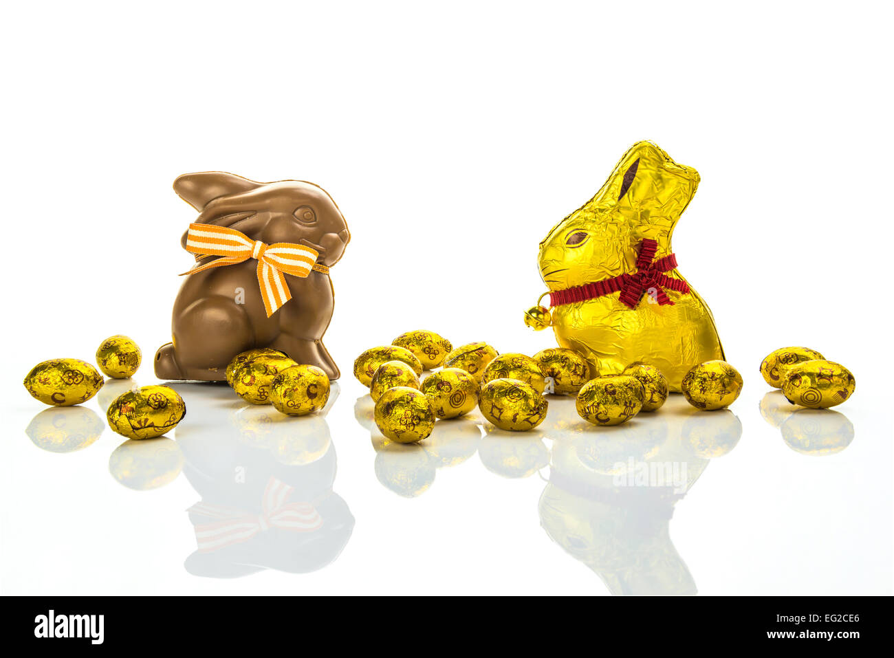 Easter chocolate bunnies and golden eggs on white background Stock ...