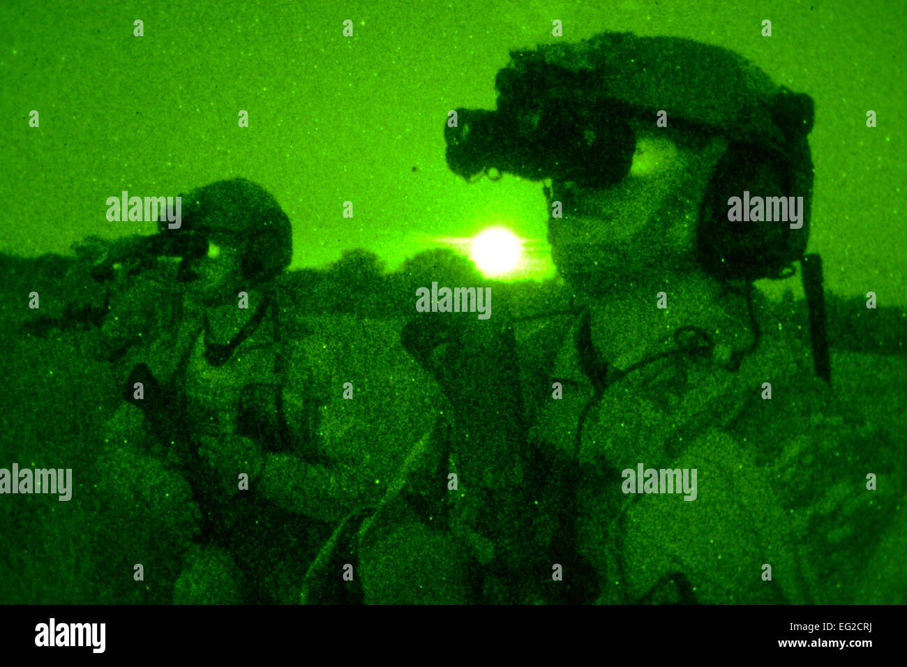 U.S. Air Force Air Commandos use night vision goggles to survey an area ...