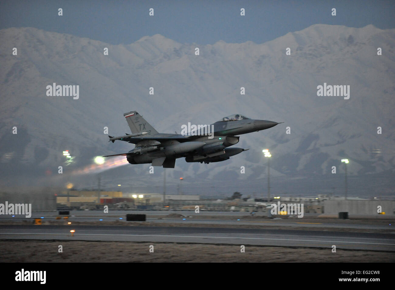 A U.S. Air Force F-16 Fighting Falcon takes off on a mission at dawn ...
