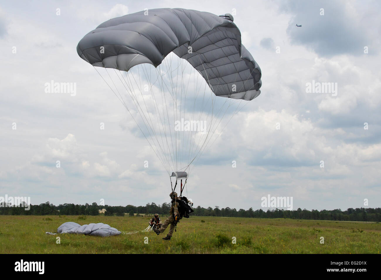 U.S. Air Force pararescuemen parachute into a landing zone at Fort Polk ...