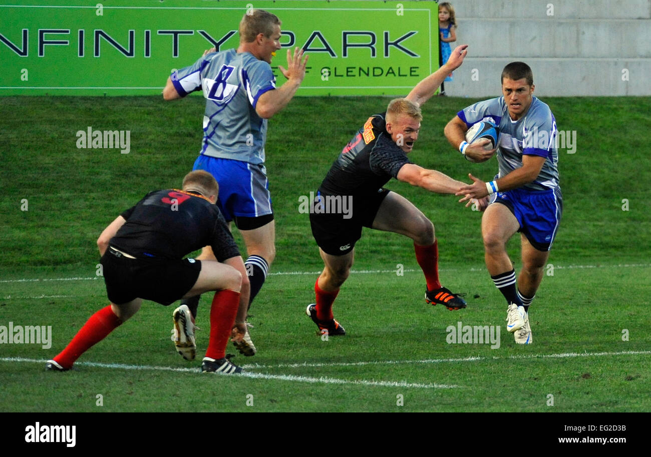Air Force rugby players run past Marine players during their first ...
