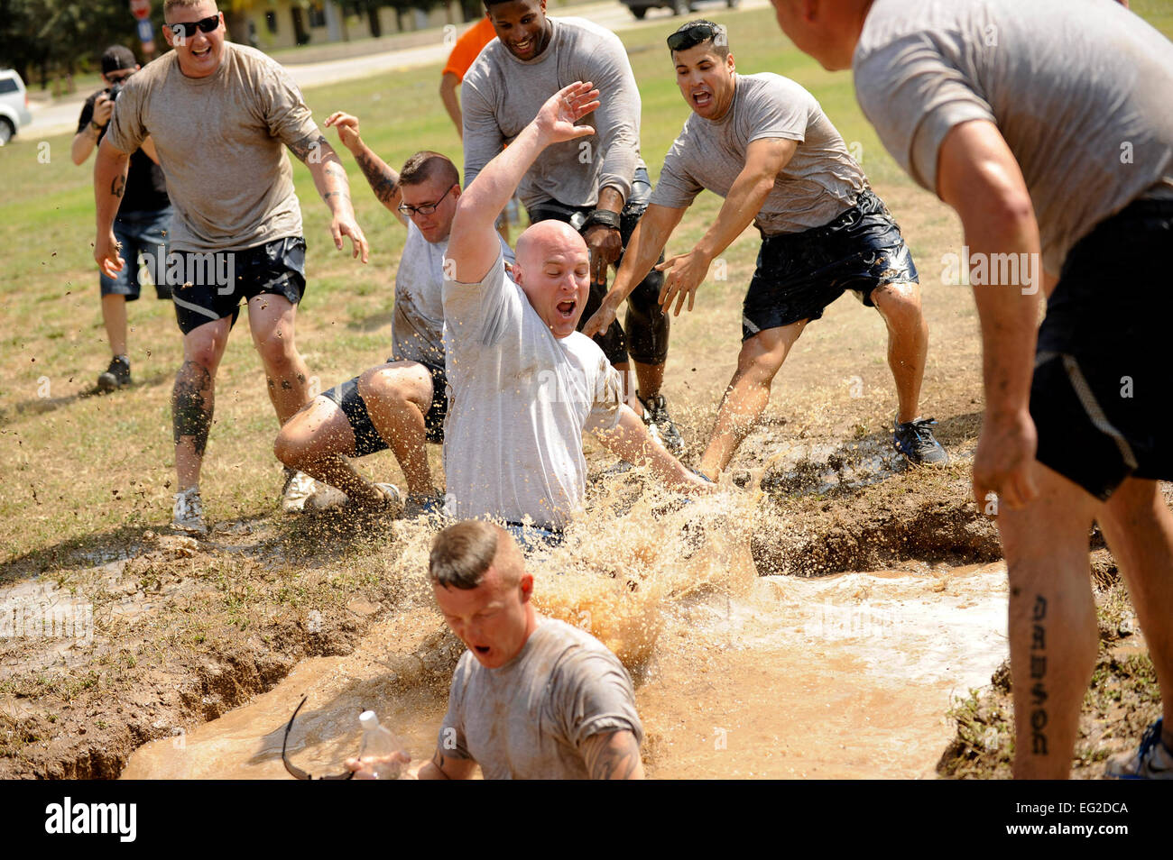 Members of the 39th Security Forces Squadron jump into the mud pit ...