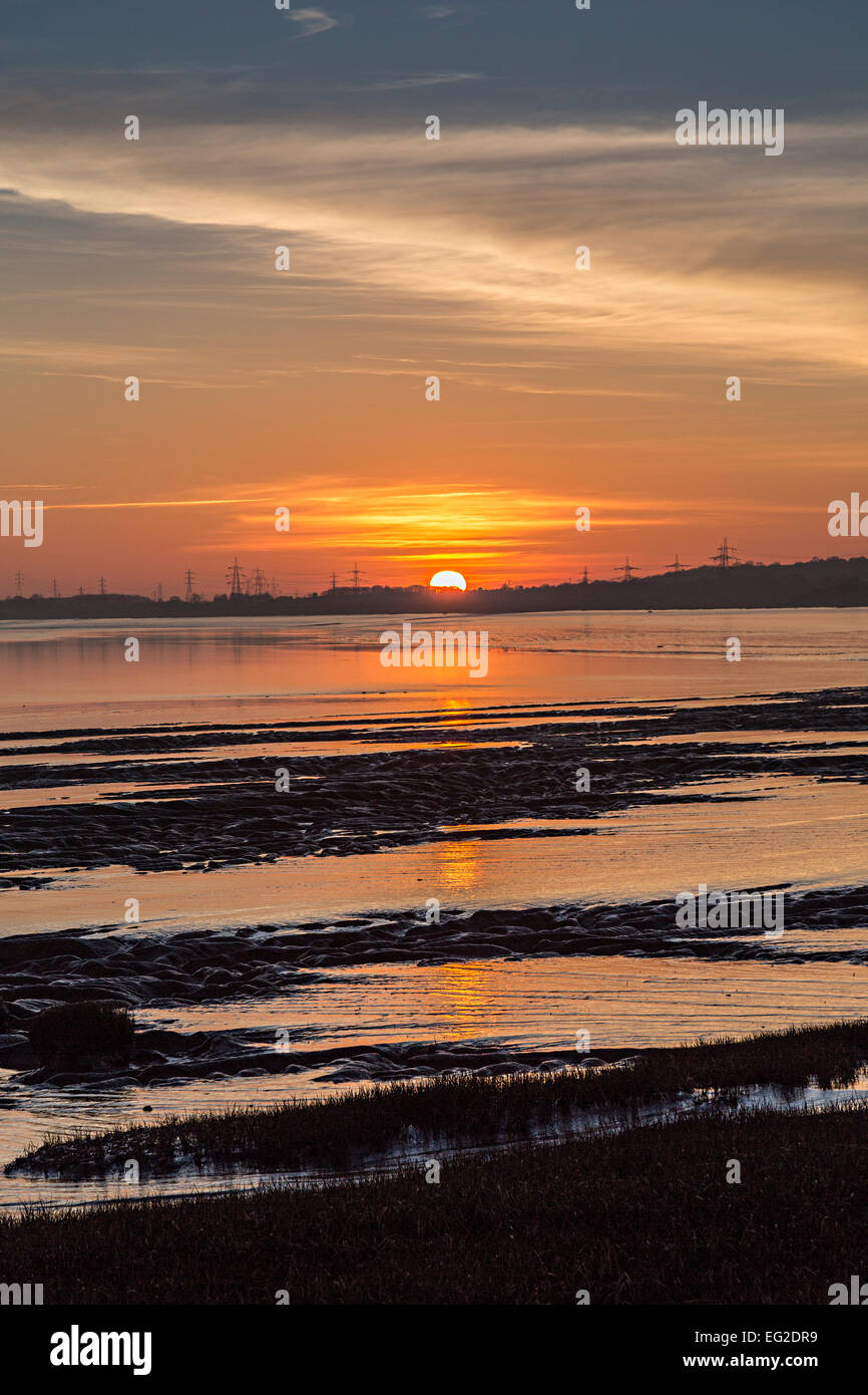 Setting sun over skyline with pylons, Beachley Point, River Severn ...