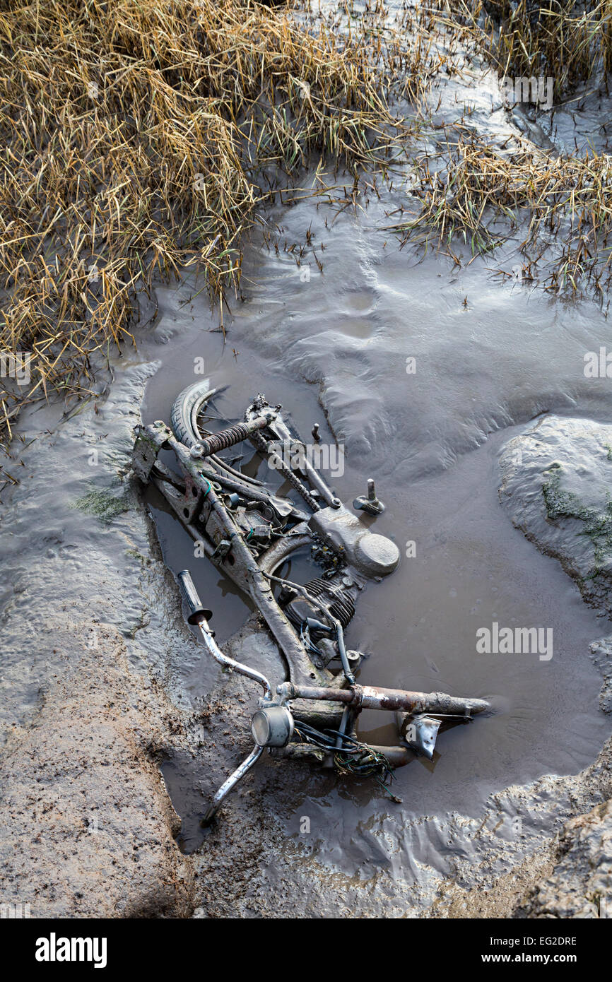 Motor cycle dumped in the mud at low tide, Beachley Point, River Severn ...