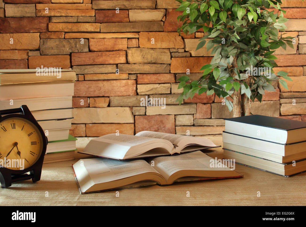 Study table with books in an office room Stock Photo - Alamy
