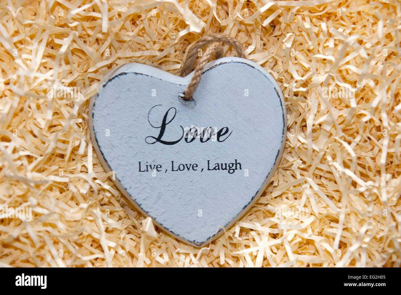 single grey wooden love heart in a love nest made of straw Stock Photo ...