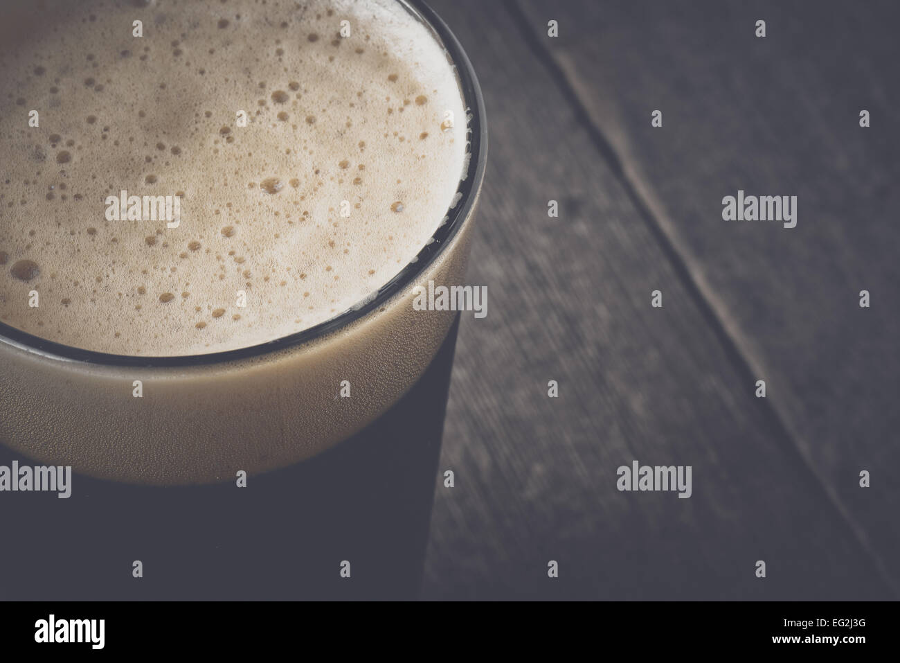 Pint of Dark Beer on Wood Background with Vintage Film Style Stock ...