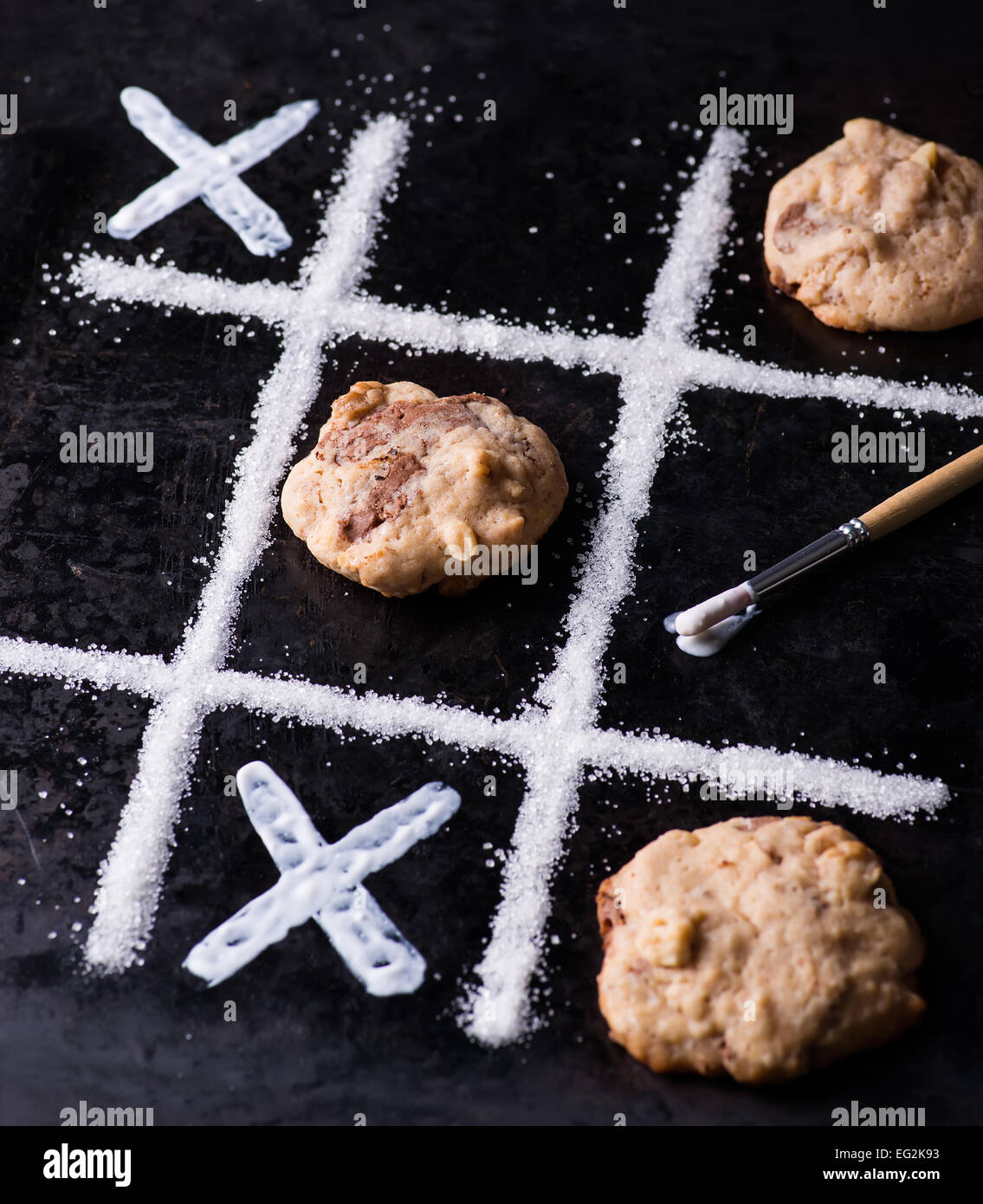 Chocolate chip cookies on noughts and crosses sugar grid, dark ...
