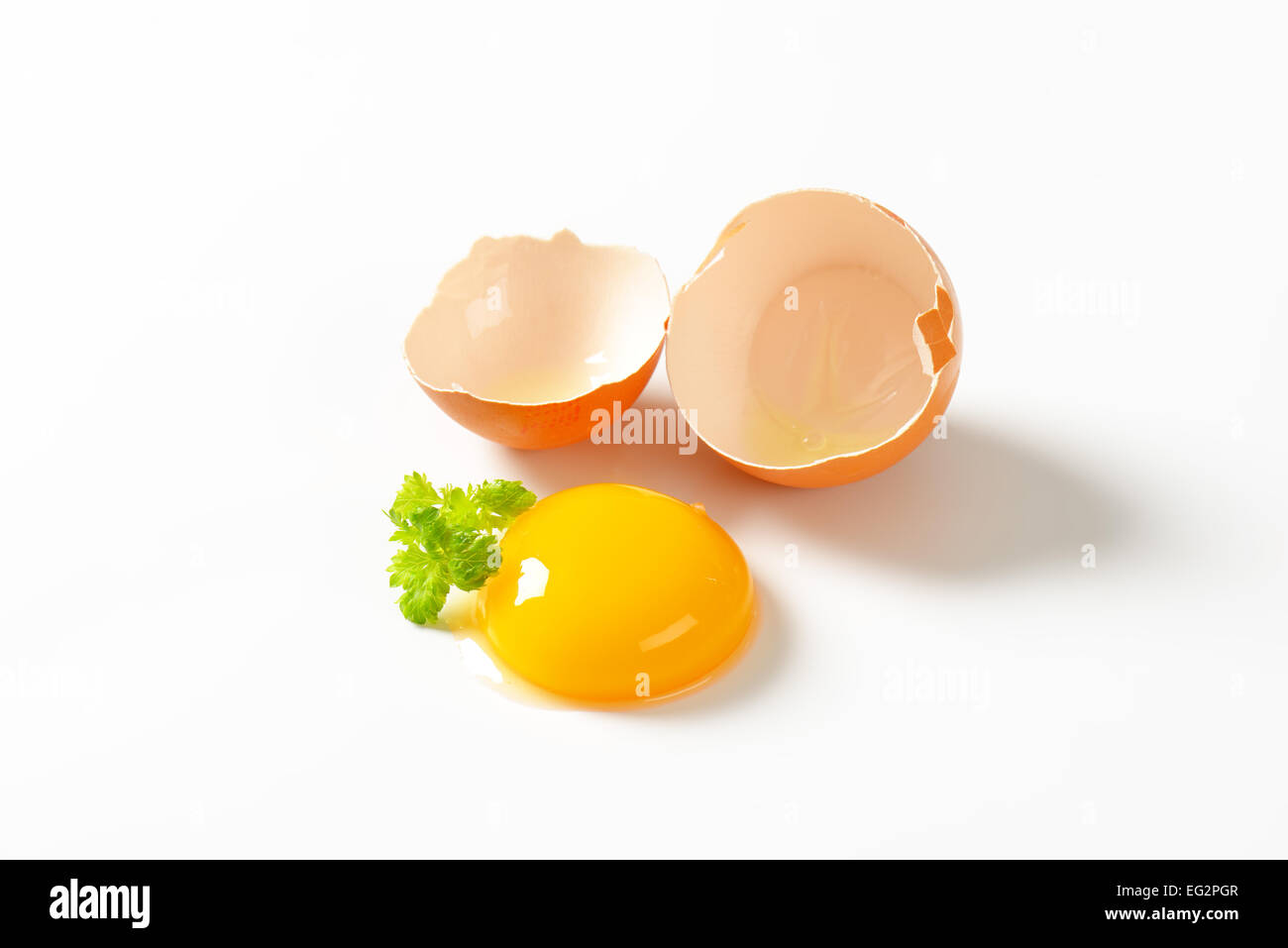 Raw egg yolk on white background Stock Photo - Alamy