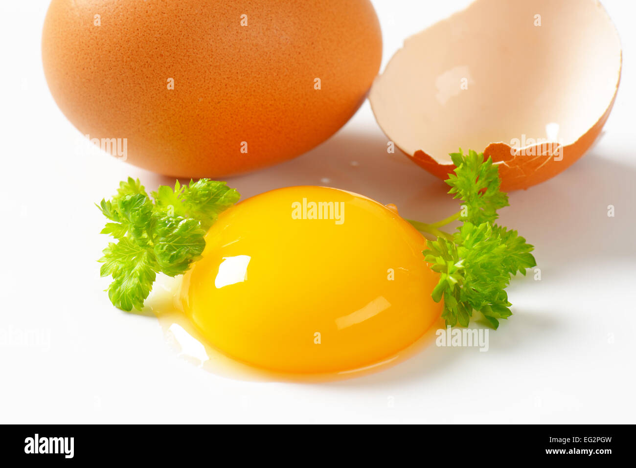 Raw egg yolk on white background Stock Photo - Alamy