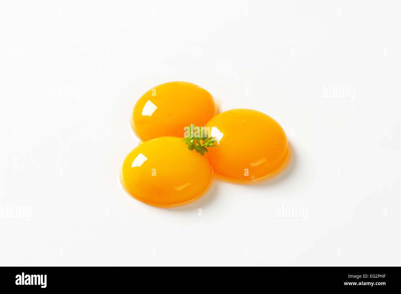 Raw egg yolk on white background Stock Photo - Alamy
