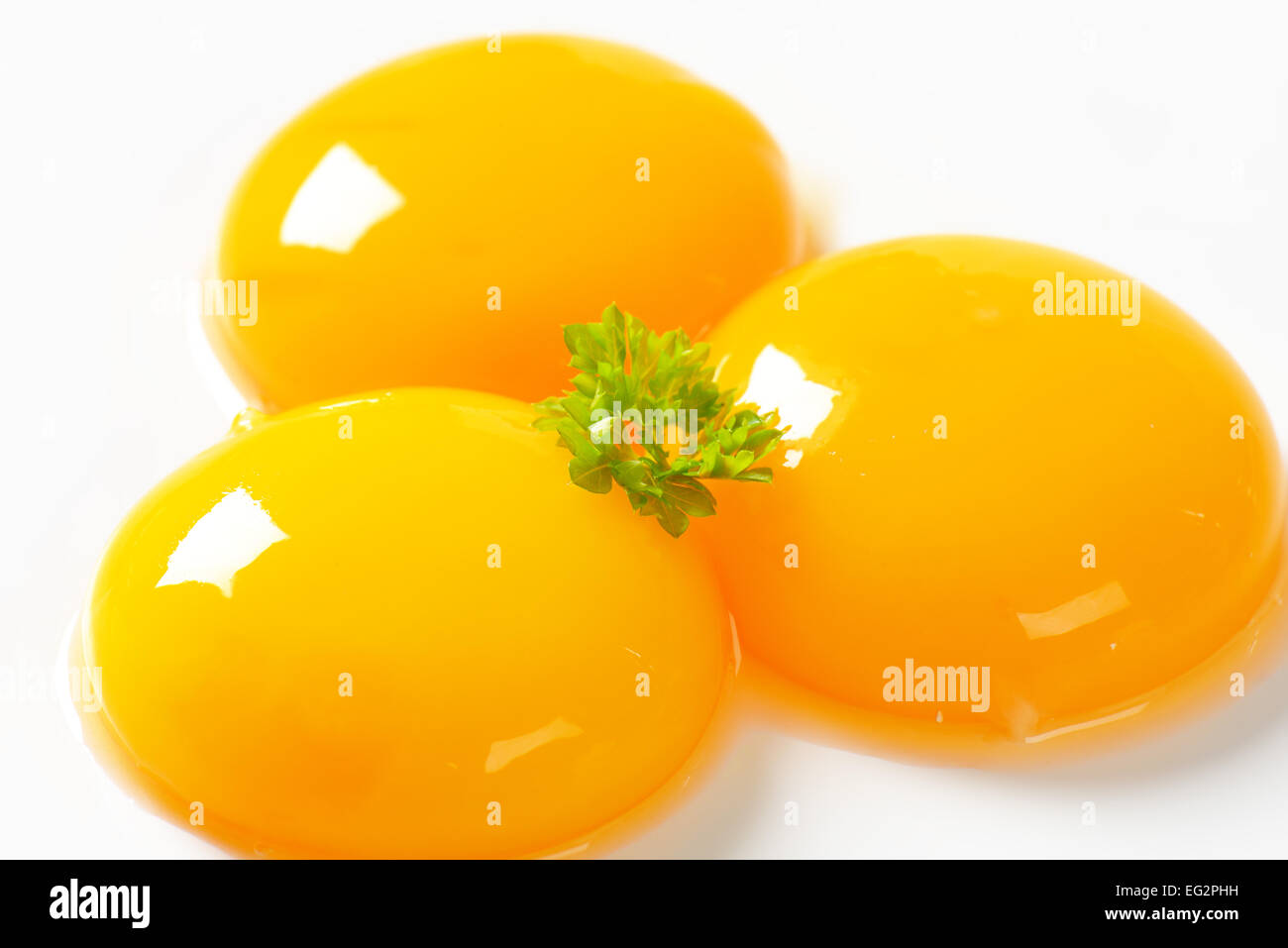 Raw egg yolk on white background Stock Photo - Alamy