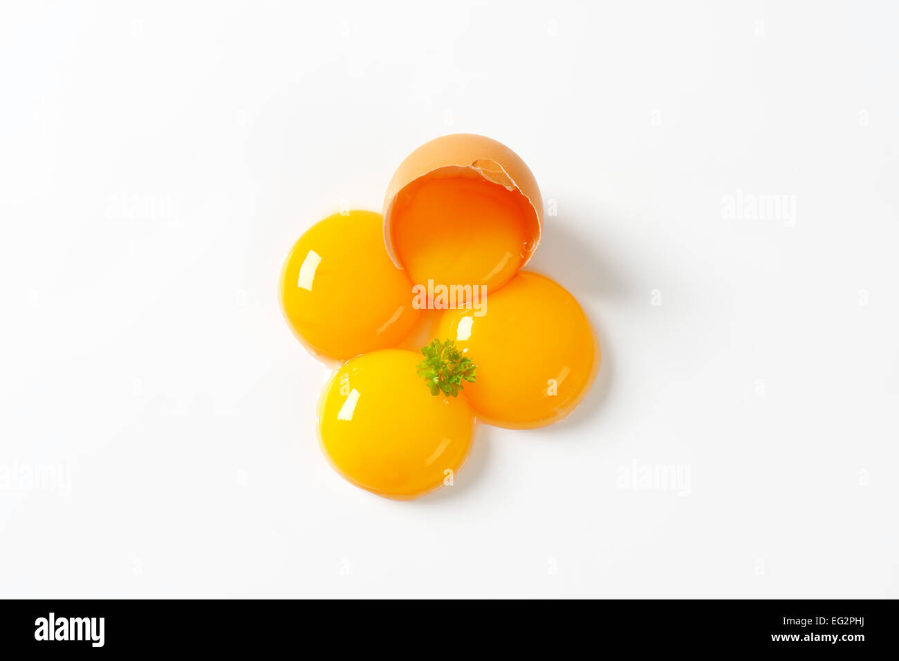 Raw egg yolk on white background Stock Photo - Alamy