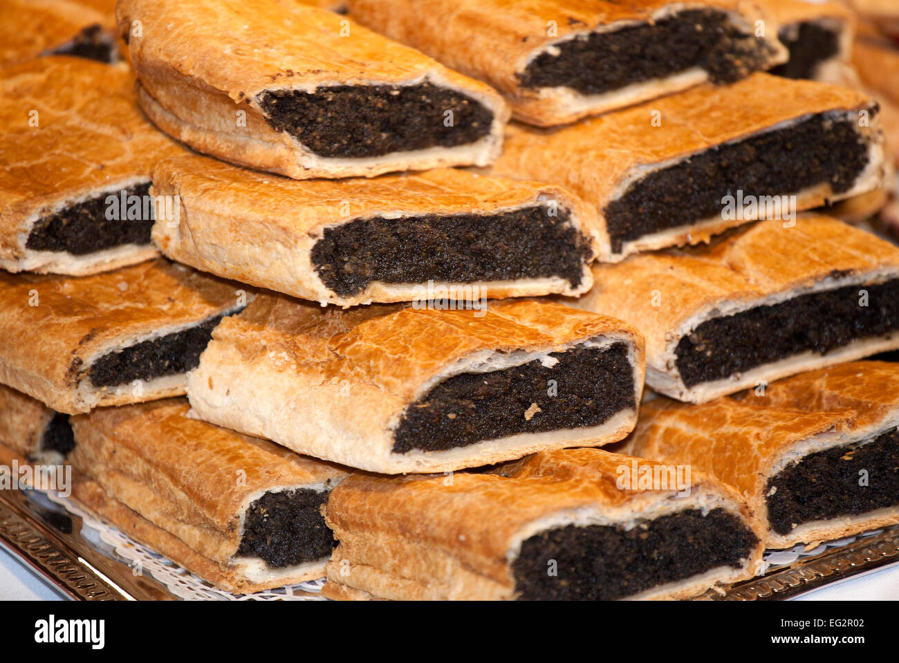 Group of cherry strudels with white dishes close up as a background ...