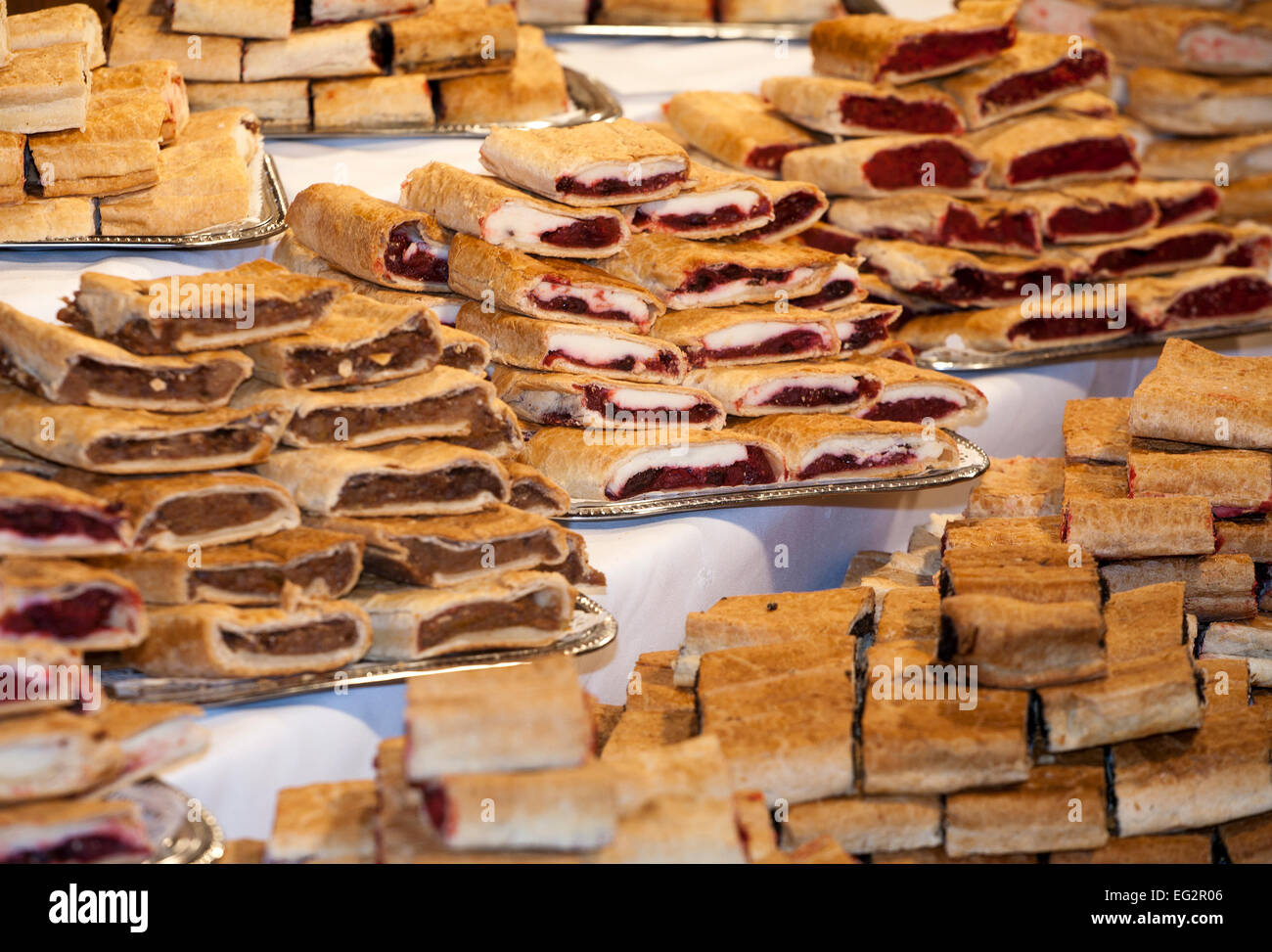 Group of cherry strudels with white dishes close up as a background ...