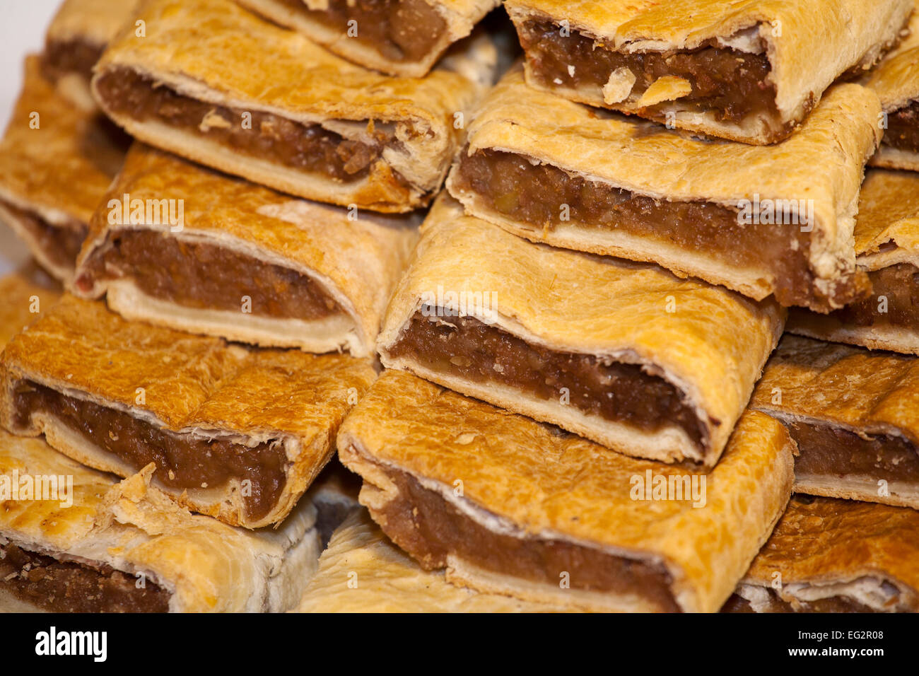 Group of cherry strudels with white dishes close up as a background ...