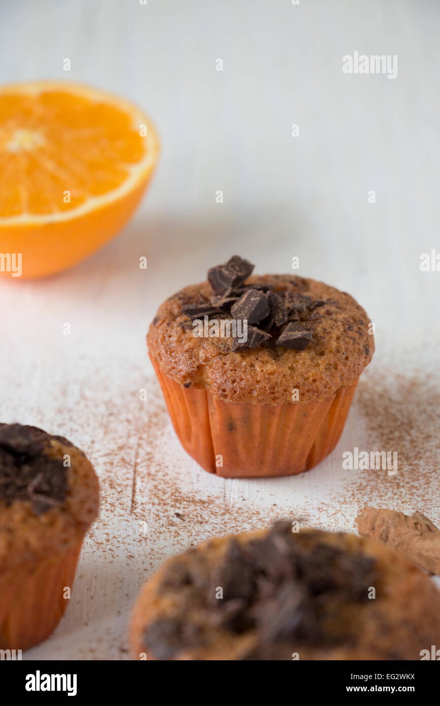 Orange and dark chocolate muffins with half orange in the back Stock ...