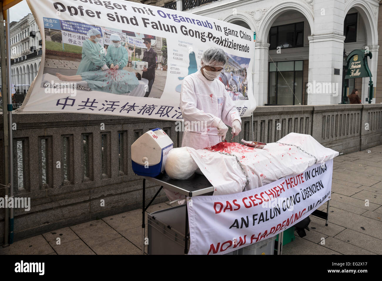 Demonstrator in a white robe represents the removal of human organs ...