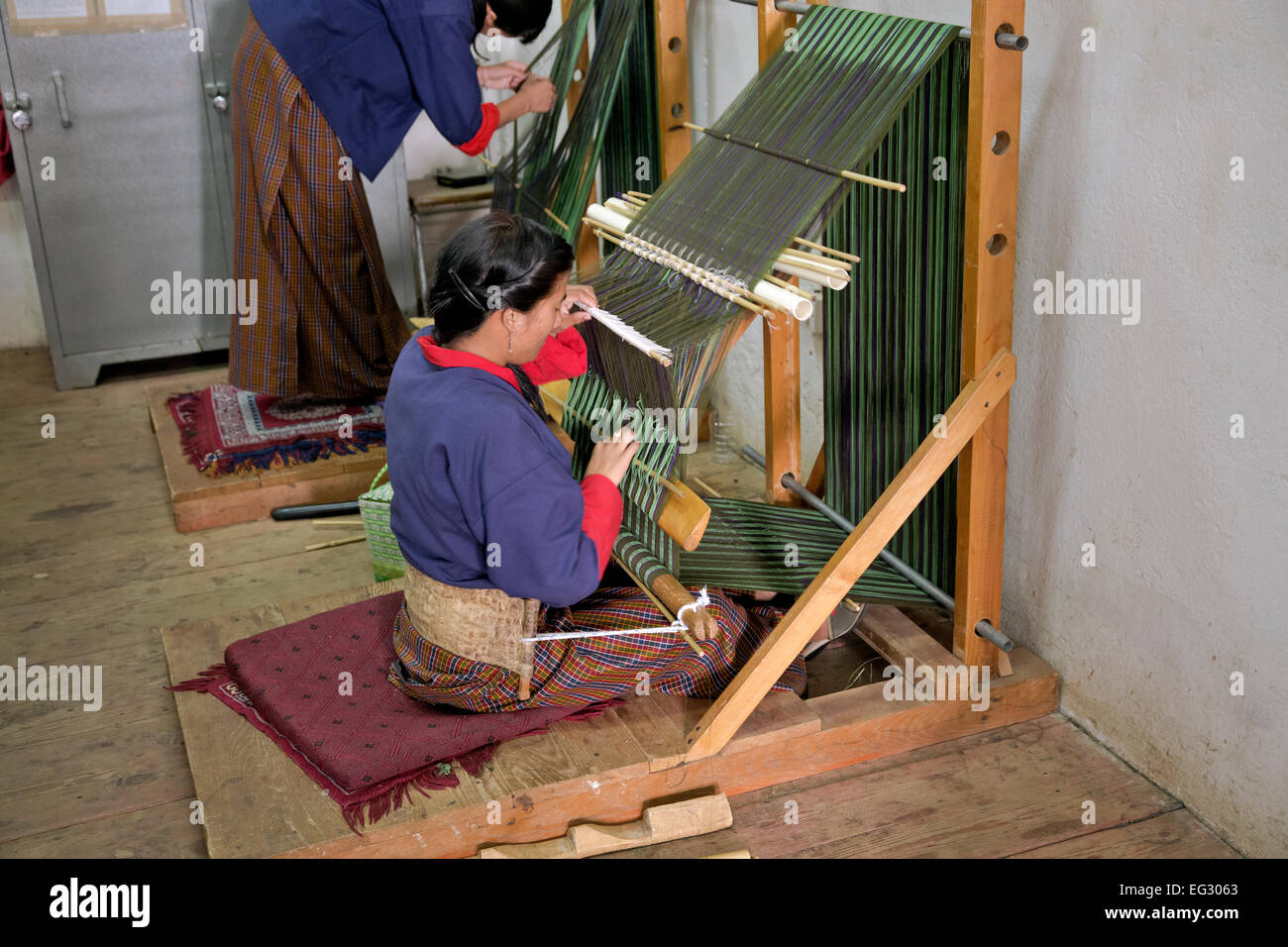 BHUTAN - Weaving complicated designs on a loom, a fabric making project ...