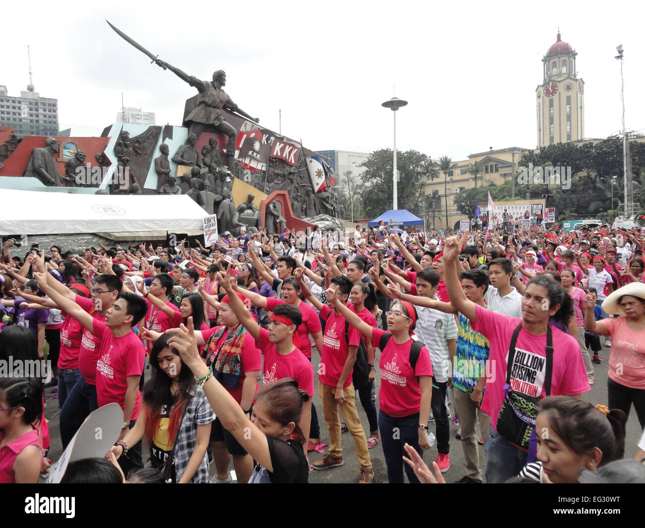 Filipinos hold their fingers up as they dance the 'One Billion Rising ...