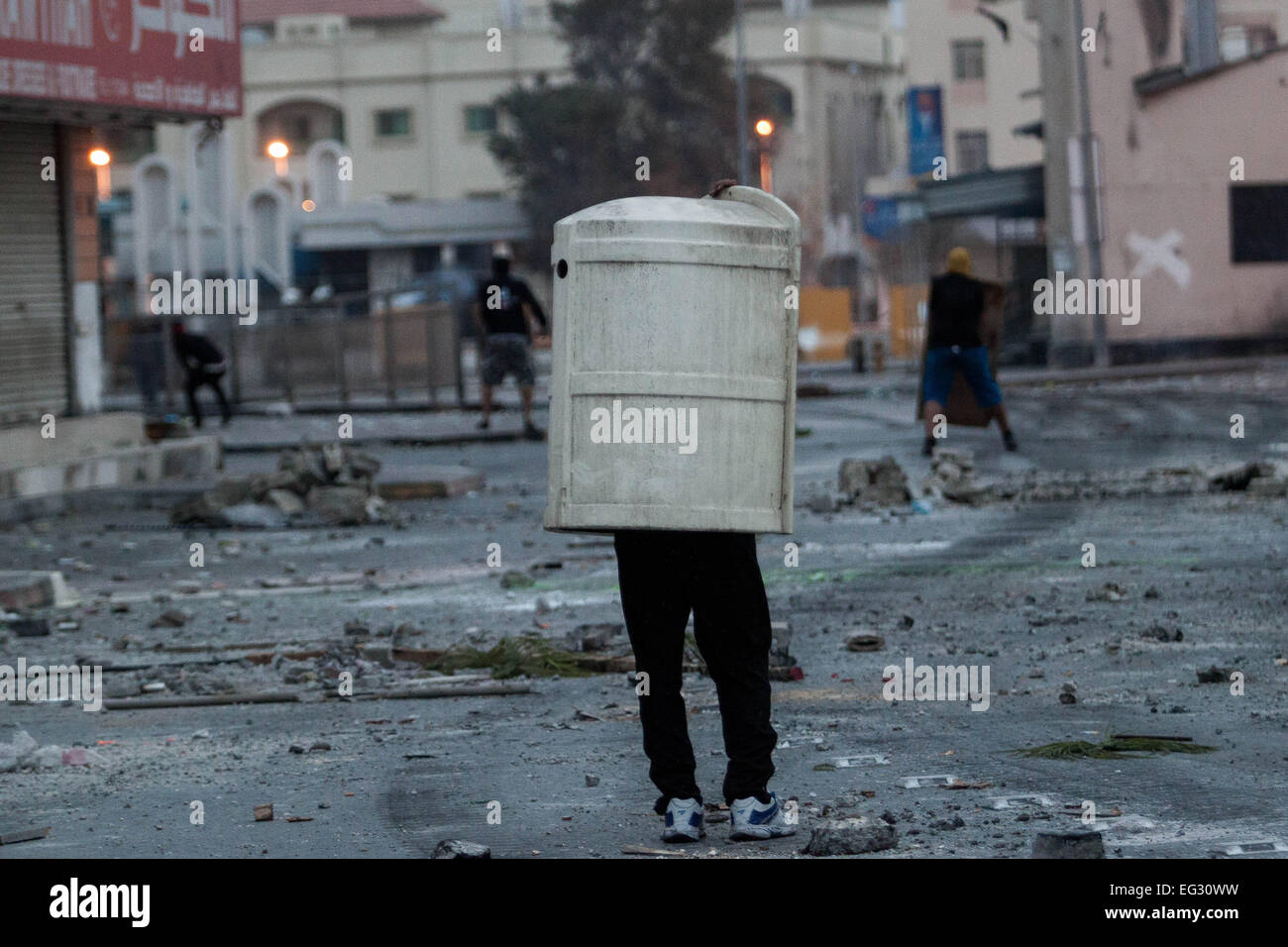 Manama, Bahrain. 14th Feb, 2015. A protester covers with water tank to ...