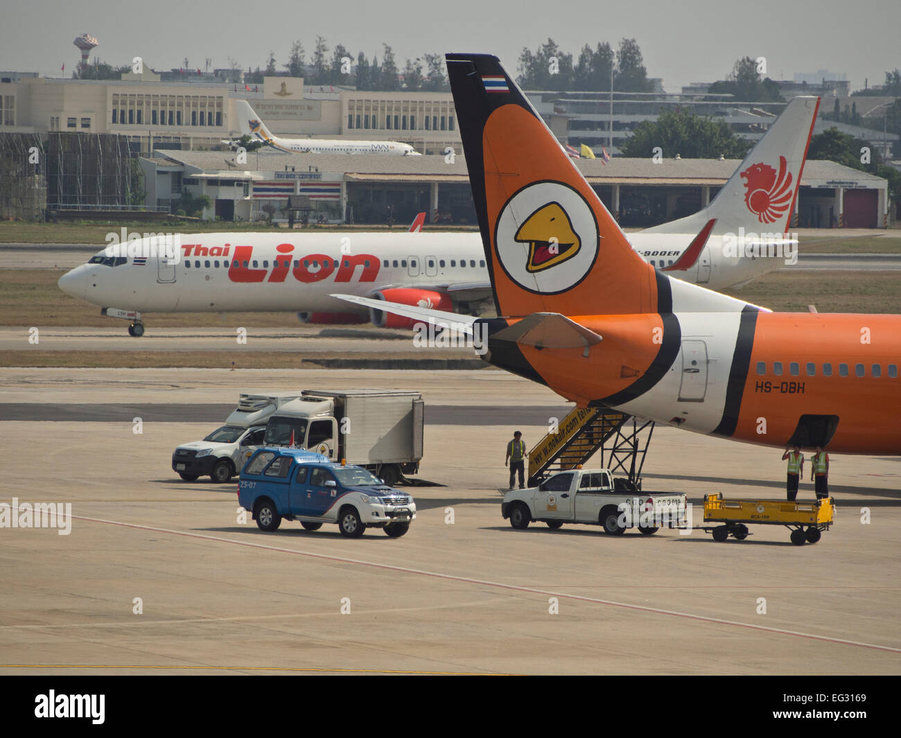 Nokair and Thai Lion airplanes being serviced before take-off at Dong ...