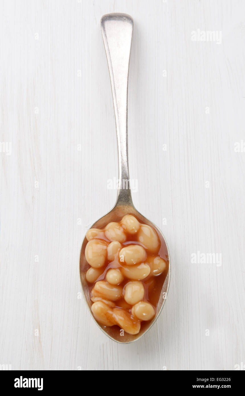 warm baked beans on a metal spoon Stock Photo - Alamy