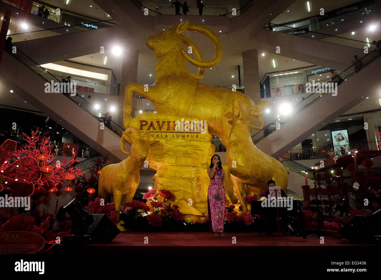 A singer performs at the lobby of a shopping mall decorated with giant ...