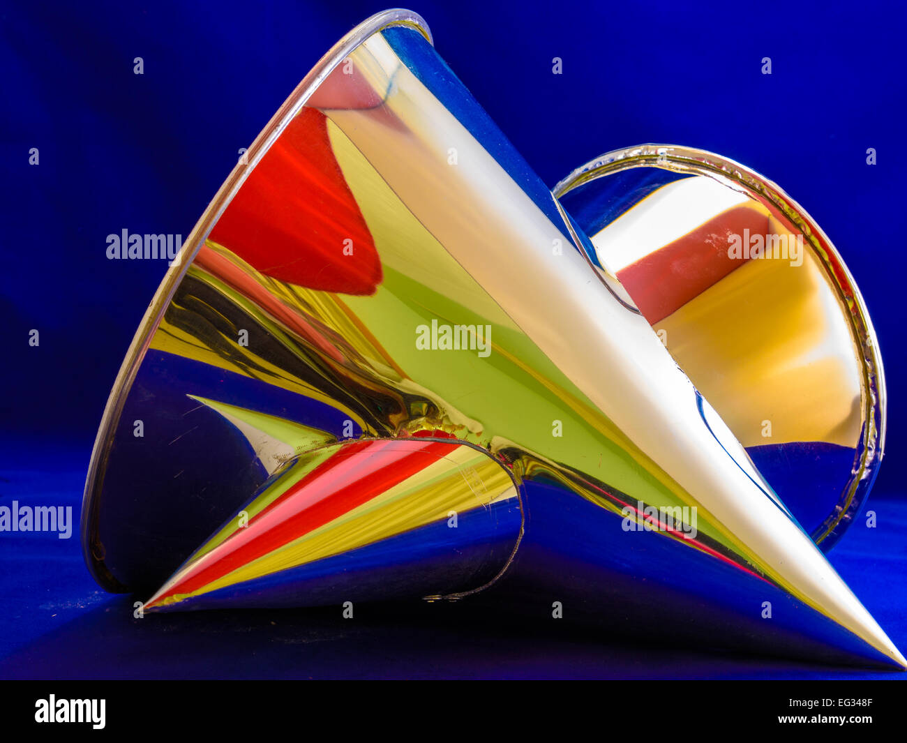 Handmade metal abstract art of intersecting cones two toned Stock Photo ...