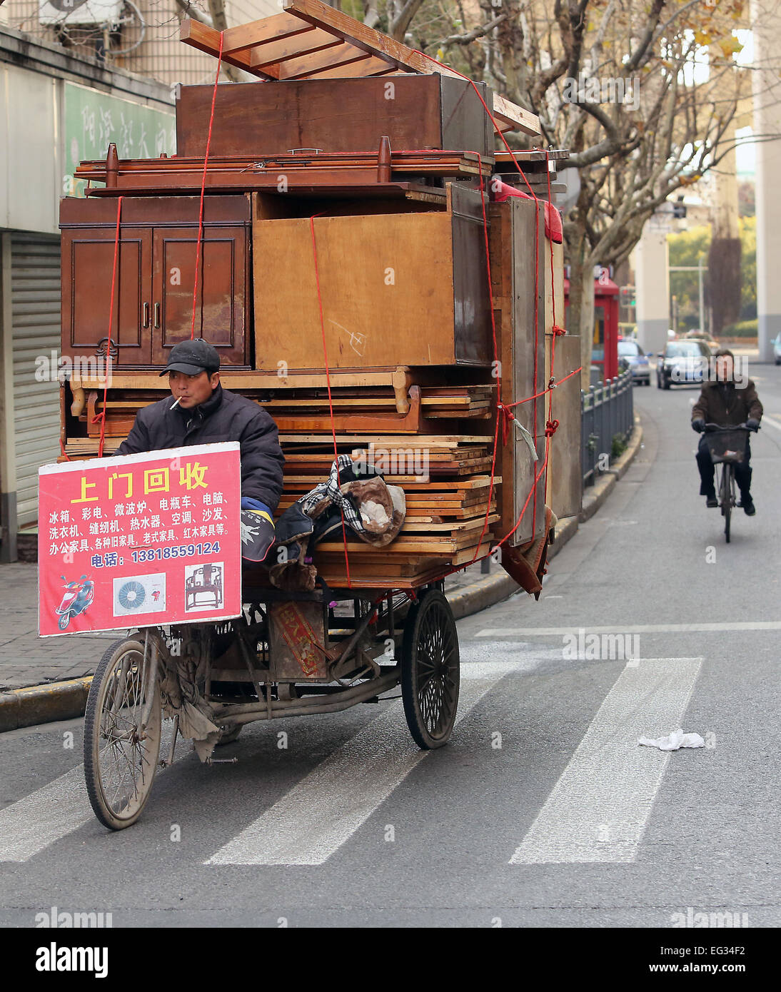 Shanghai, CHINA. 2nd Feb, 2015. A Chinese man sits on his heavily ...