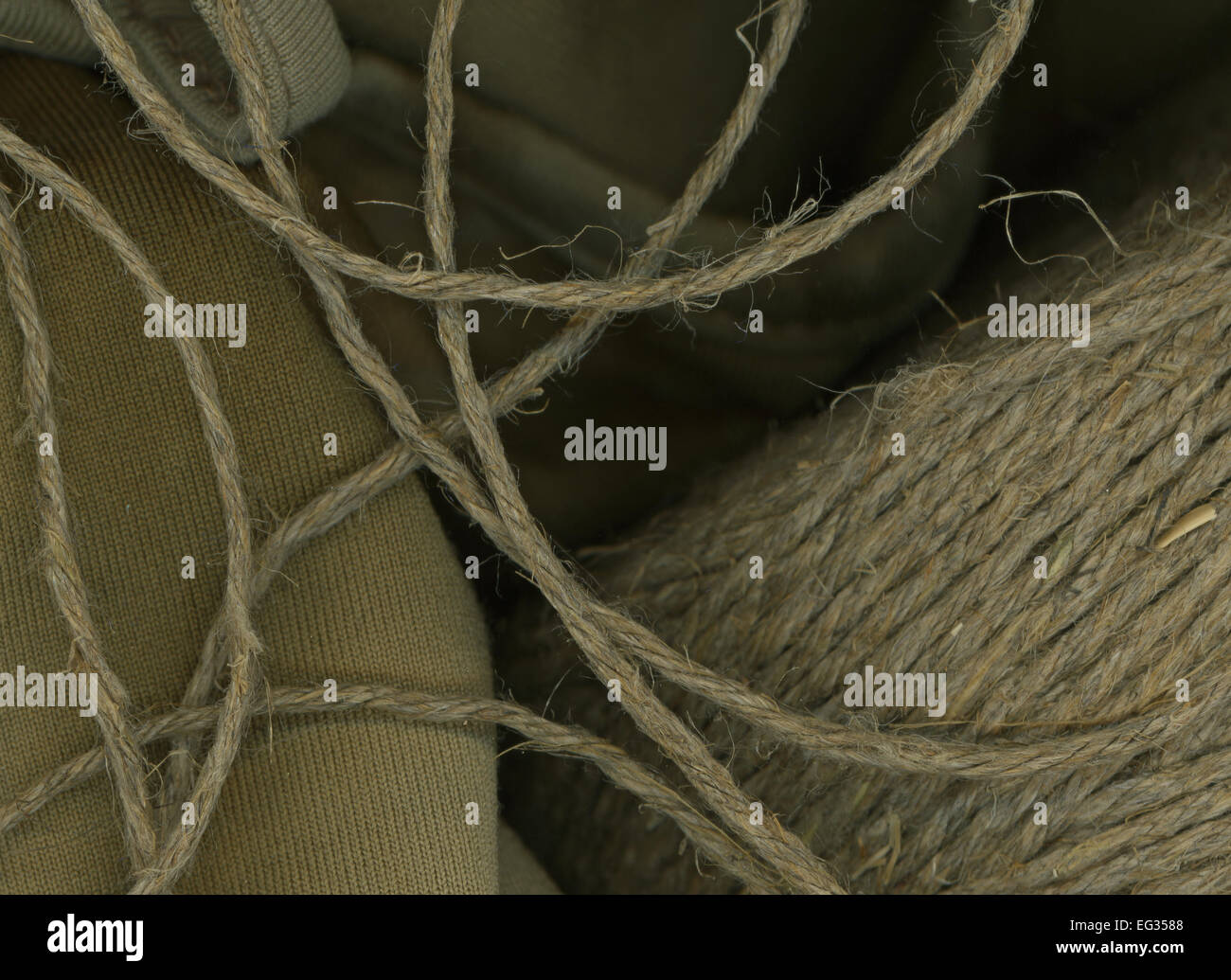 Rusty old rolled string on camouflage background Stock Photo - Alamy