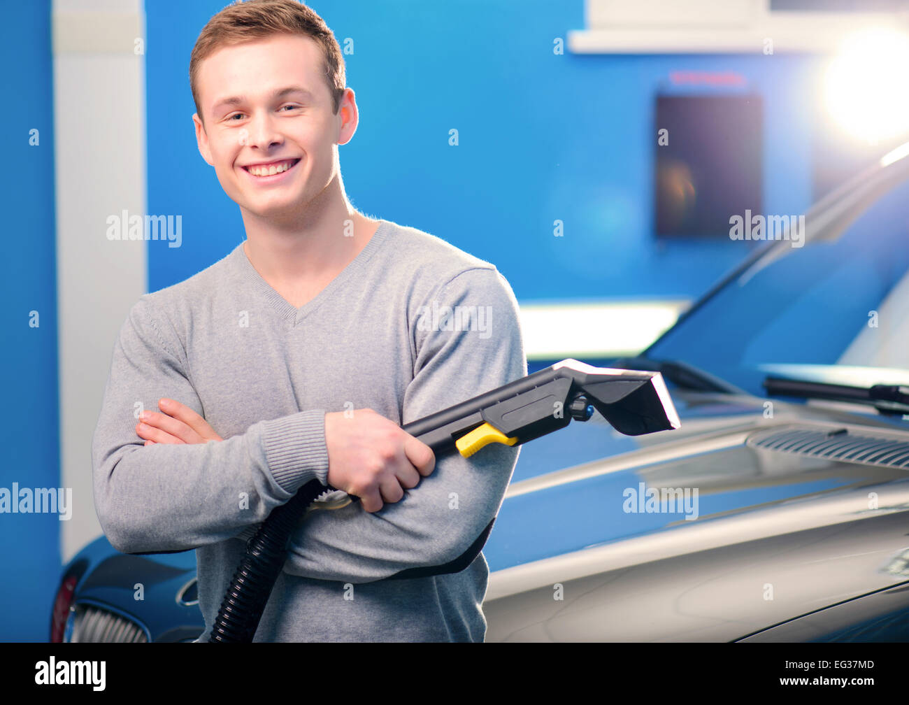 Handsome man cleaning his car Stock Photo - Alamy