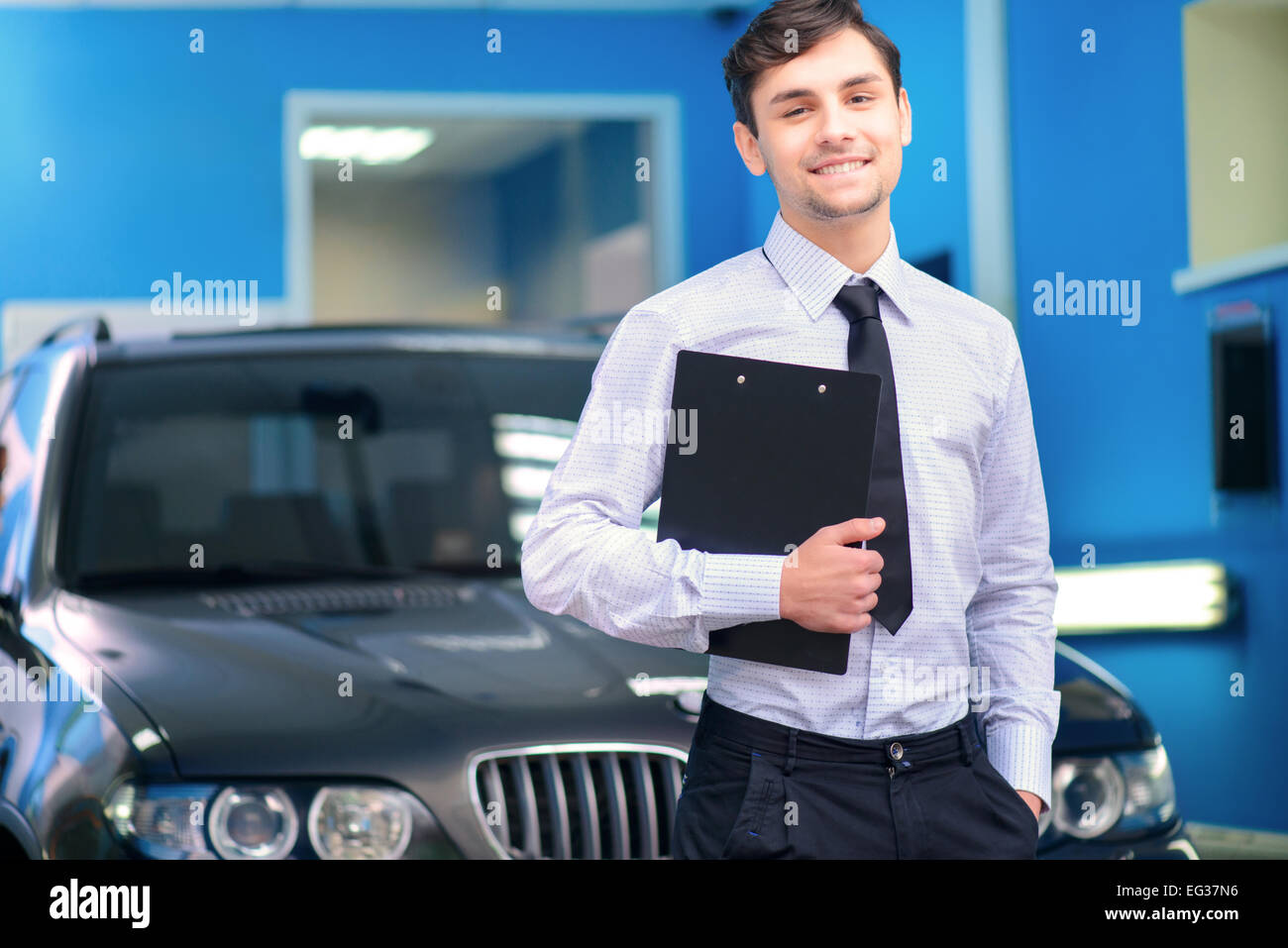 Car service manager posing with a clipboard Stock Photo - Alamy