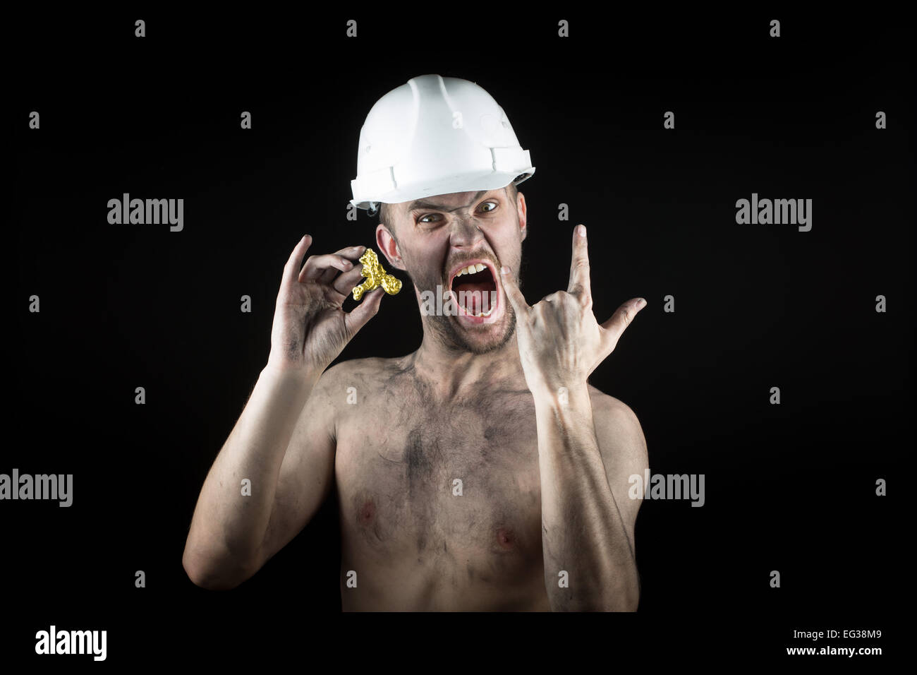 happy miner shows a golden nugget Stock Photo - Alamy