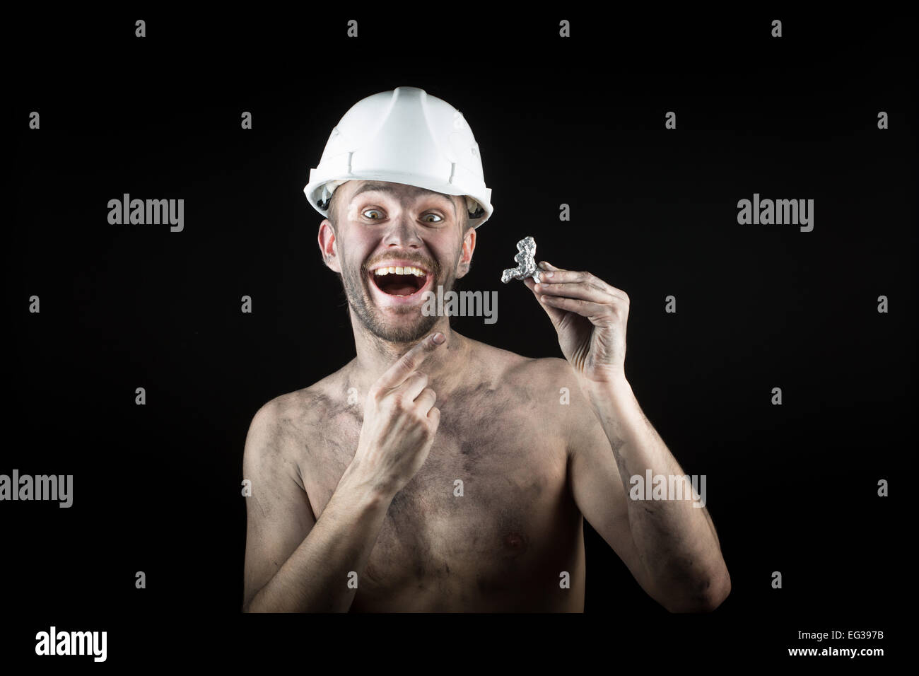 happy miner shows a silver nugget Stock Photo - Alamy