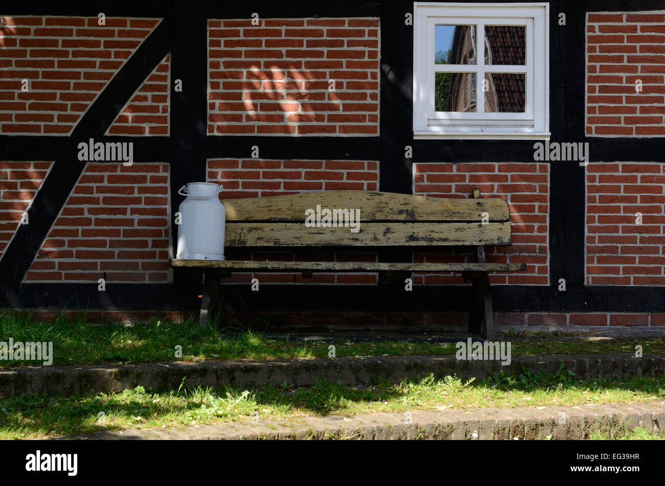 Milk can on a bench Stock Photo - Alamy
