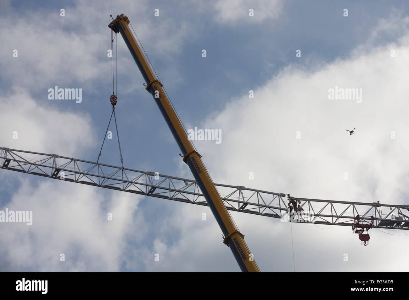 Workmen high on the jib of a crane that will construct the King's ...