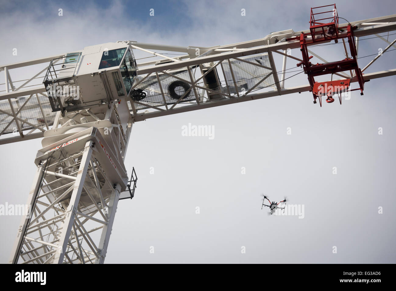 Workmen high on the jib of a crane that will construct the King's ...