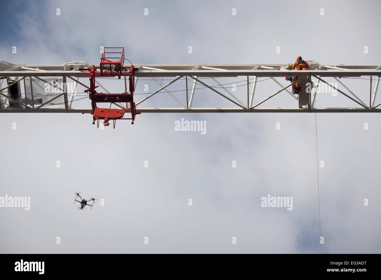 Workmen high on the jib of a crane that will construct the King's ...