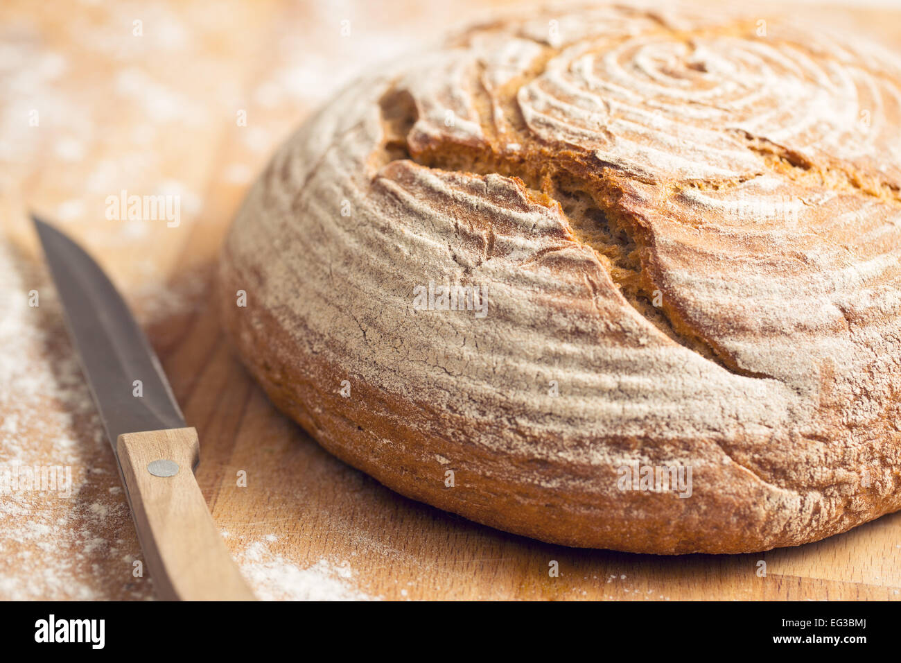 round bread on wooden table Stock Photo - Alamy