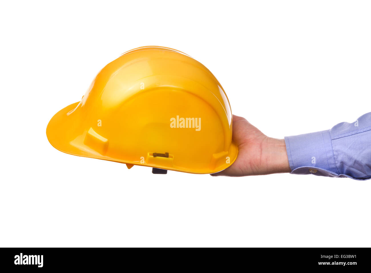 Male worker's hand holding yellow industrial protective helmet. Part of ...