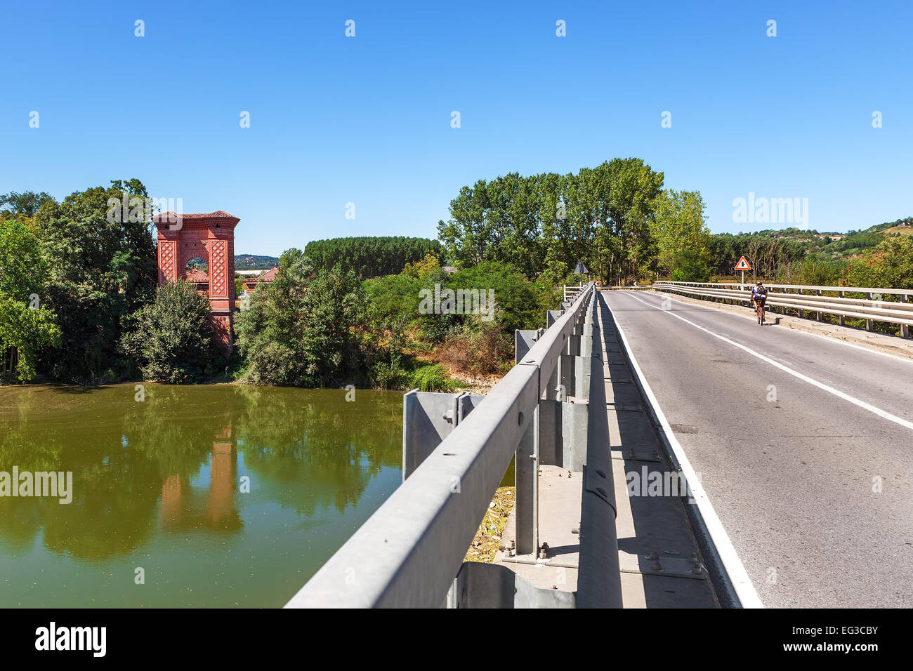 Bridge across green water of Tanaro river in Piedmont, Northern Italy ...