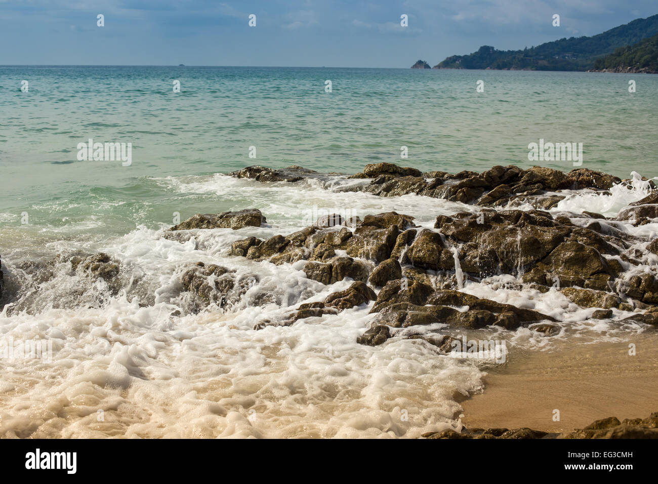 The waves breaking on a stony beach, forming a spray Stock Photo - Alamy