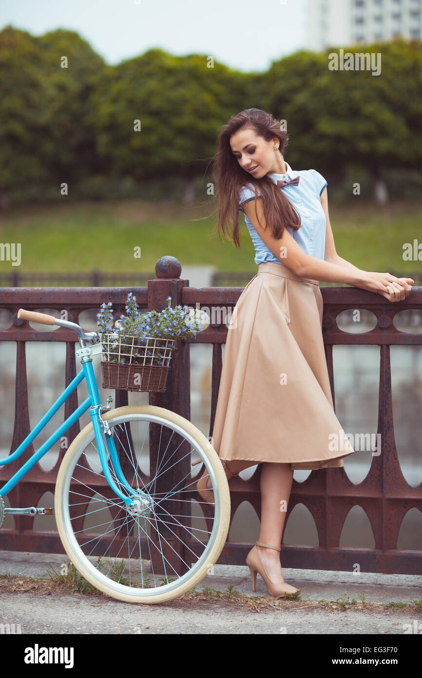 Young beautiful, elegantly dressed woman with bicycle. Beauty, fashion ...