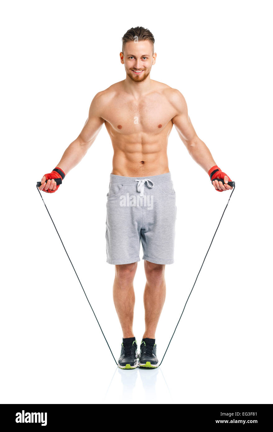 Athletic attractive man jumping on a rope on the white background Stock ...